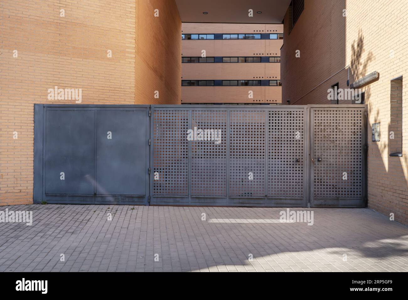 Gray painted metal access portal to a residential building with clay ...