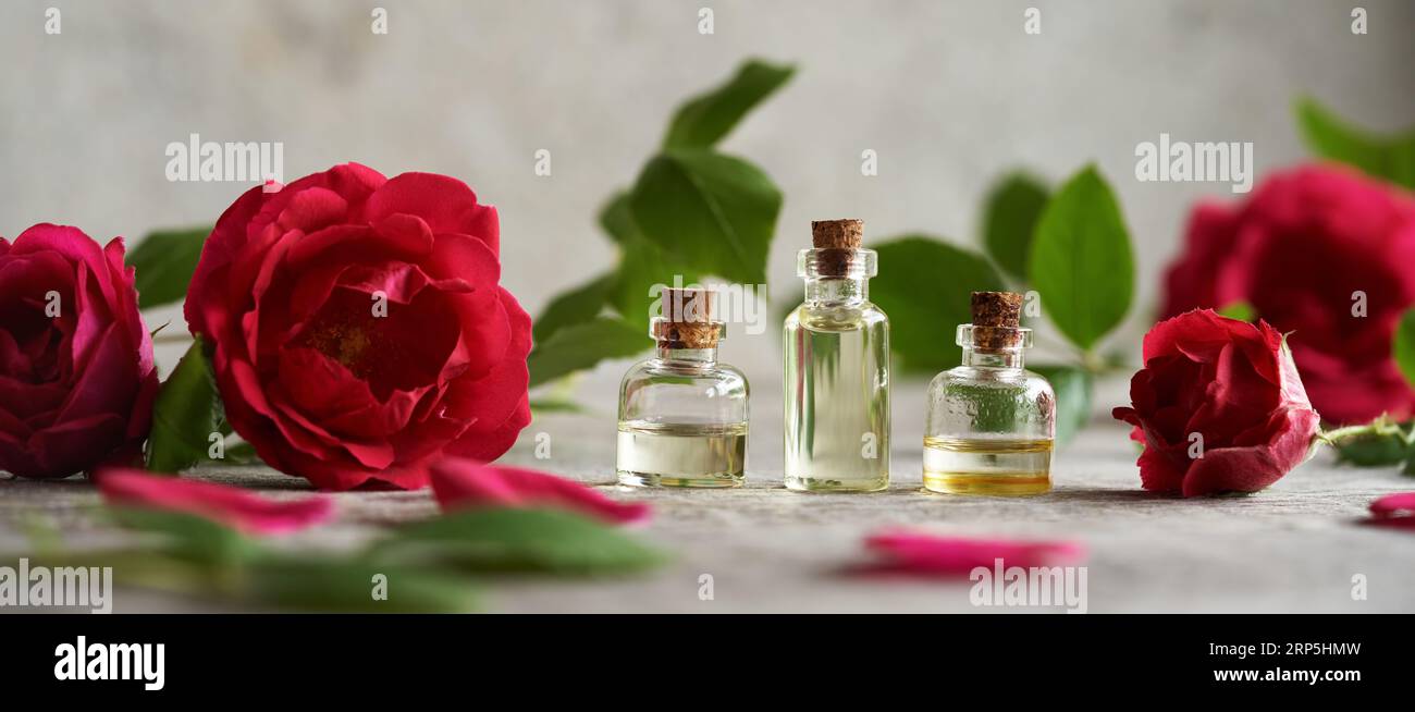 Horizontal banner with bottles of aromatherapy essential oil with red ...