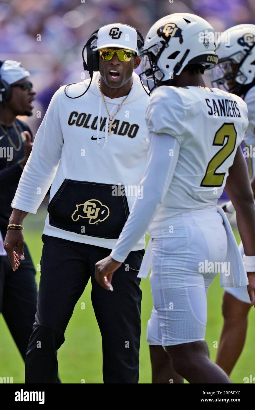 Colorado head coach Deion Sanders, right, talks to his son quarterback ...