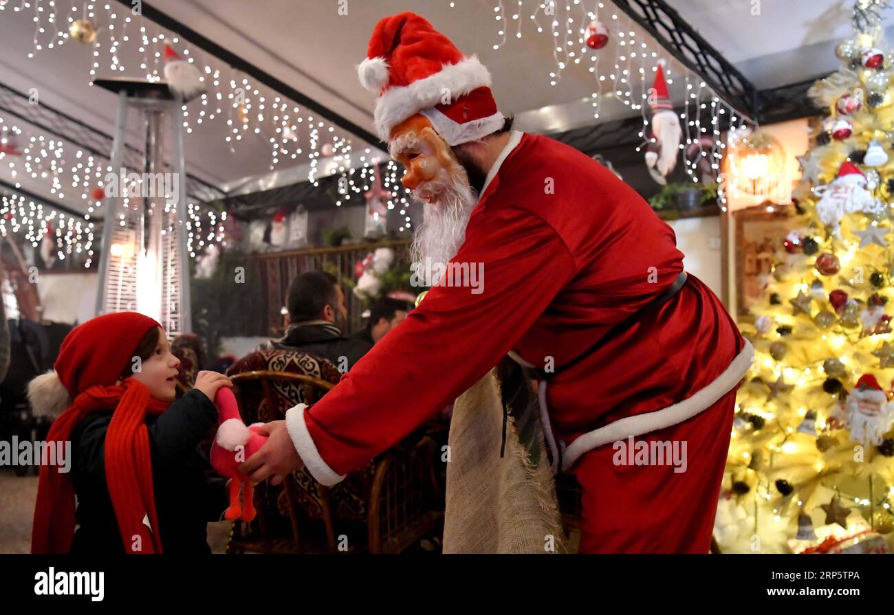 (181223) -- ALEPPO (SYRIA), Dec. 23, 2018 -- A person dressed as Santa ...