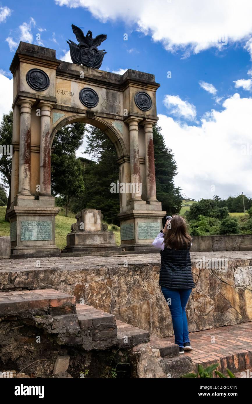 Female tourist taking pictures at the Arch of Triumph in Boyaca built ...