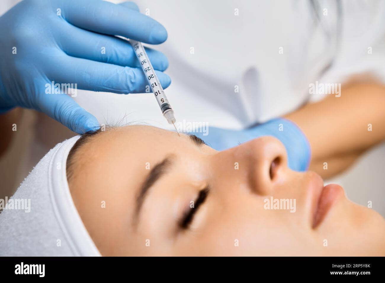Young woman getting a rejuvenating facial injection in the clinic ...