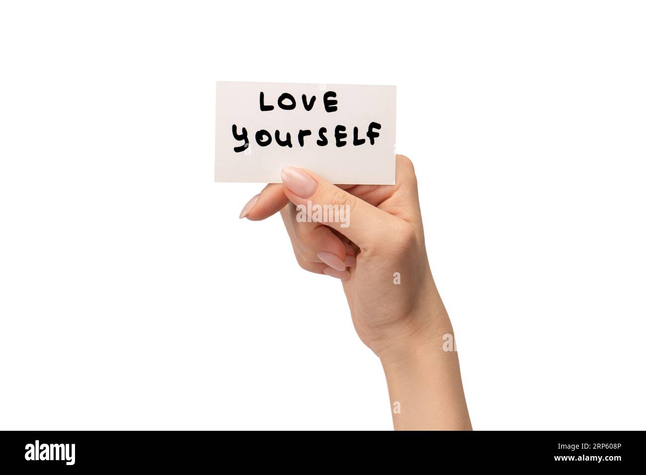 Love yourself text on a card in a woman hand isolated on a white ...