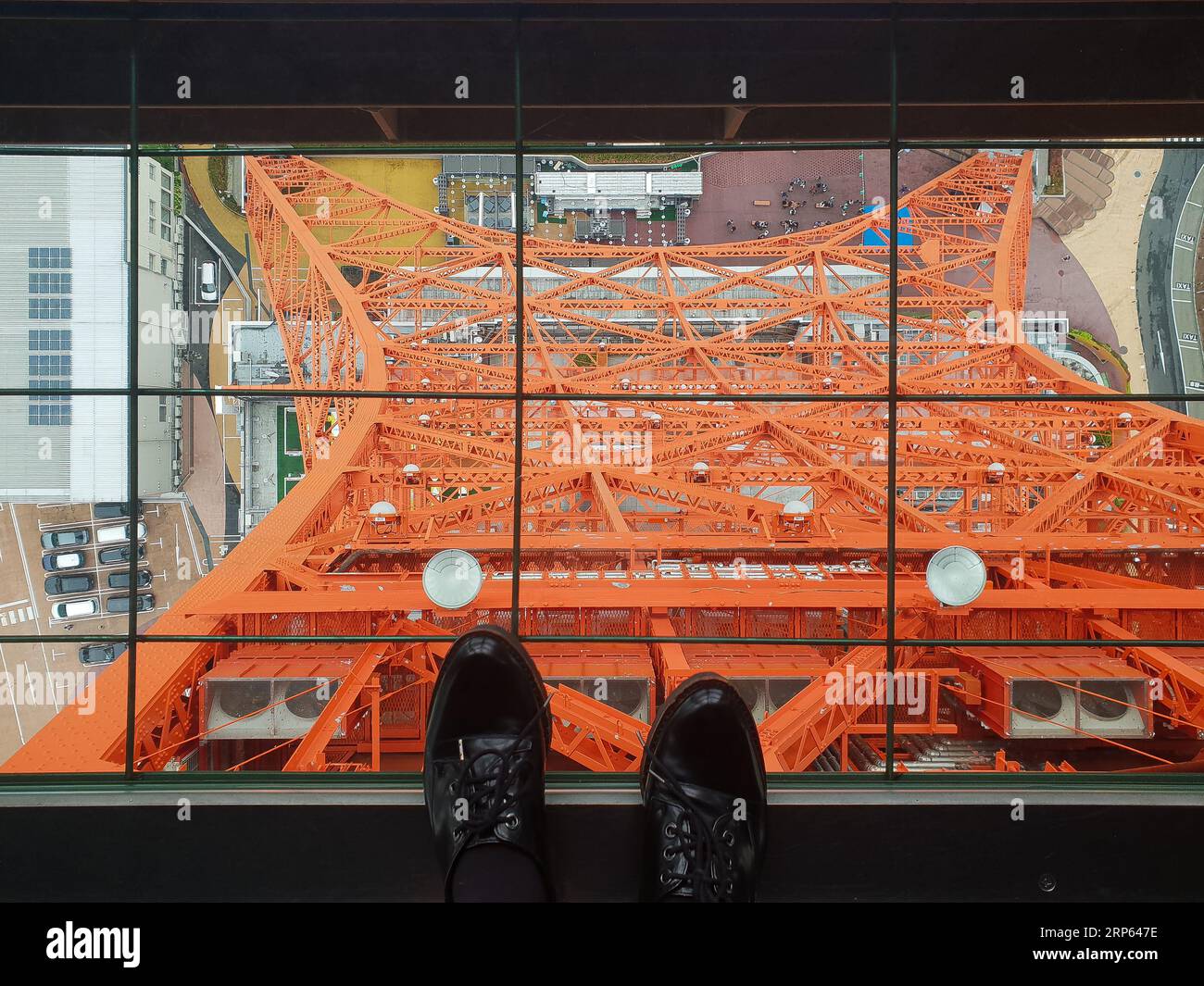 Female feet wearing black shoes and tights stand on a glass floor ...