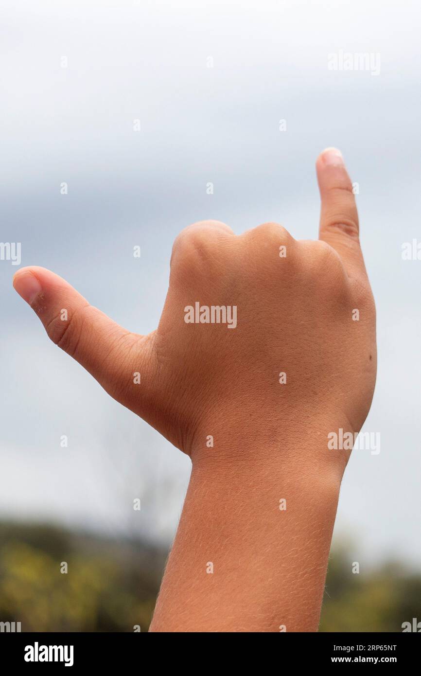 Child's hand making different shapes, either raising a finger, raising ...