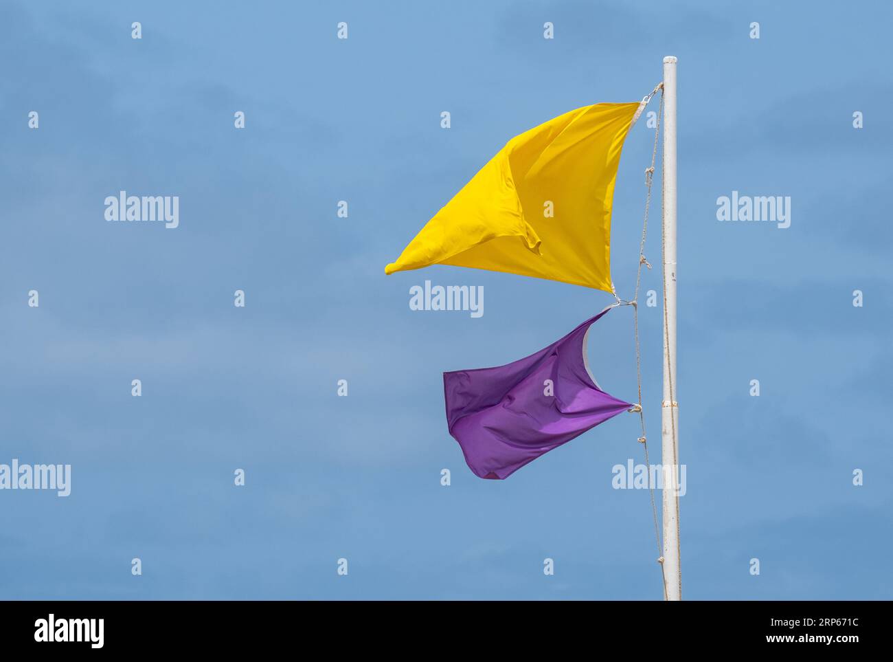 Yellow and purple flags on beach in Spain. Purple flag indicates ...