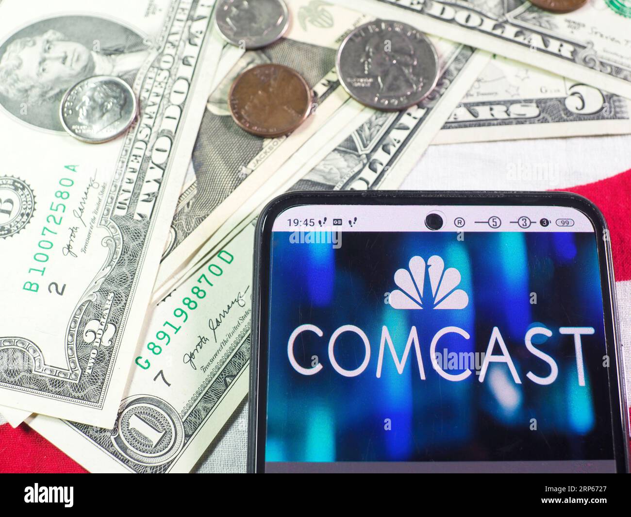 In this photo illustration, Comcast Corporation logo is seen displayed ...