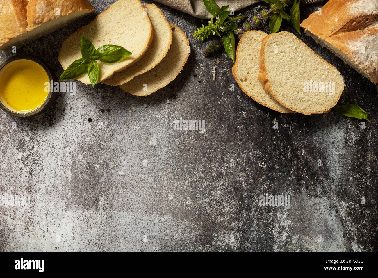 Sliced Italian ciabatta bread with extra virgin olive oil and herb on a ...