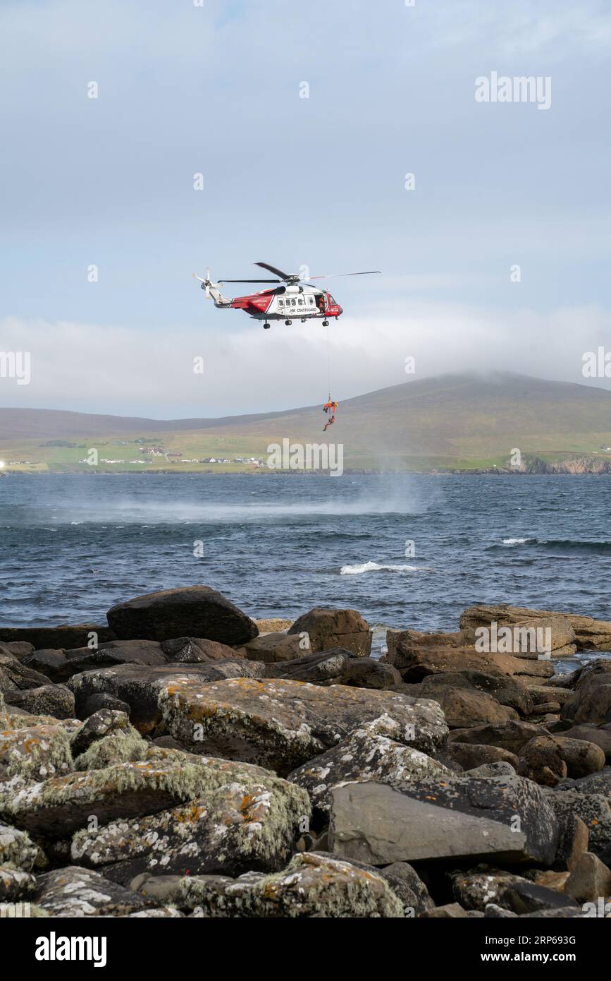 Shetland coast guard helicopter practicing a sea rescue hi-res stock ...
