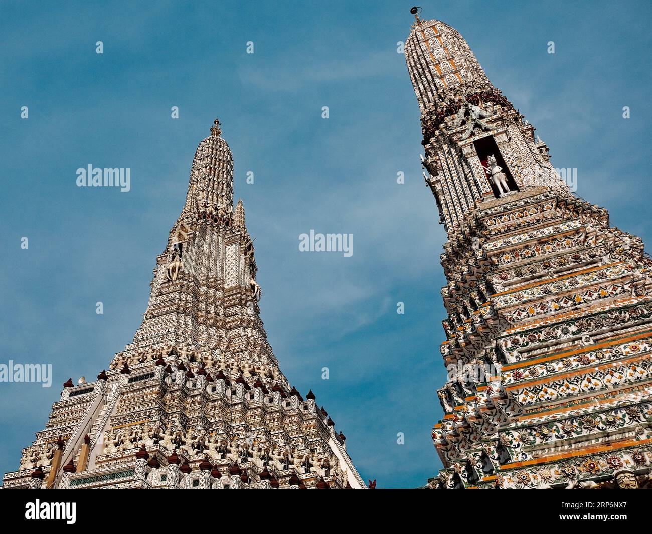 Two temple spires in Thailand. The spires are tall and ornate, with ...
