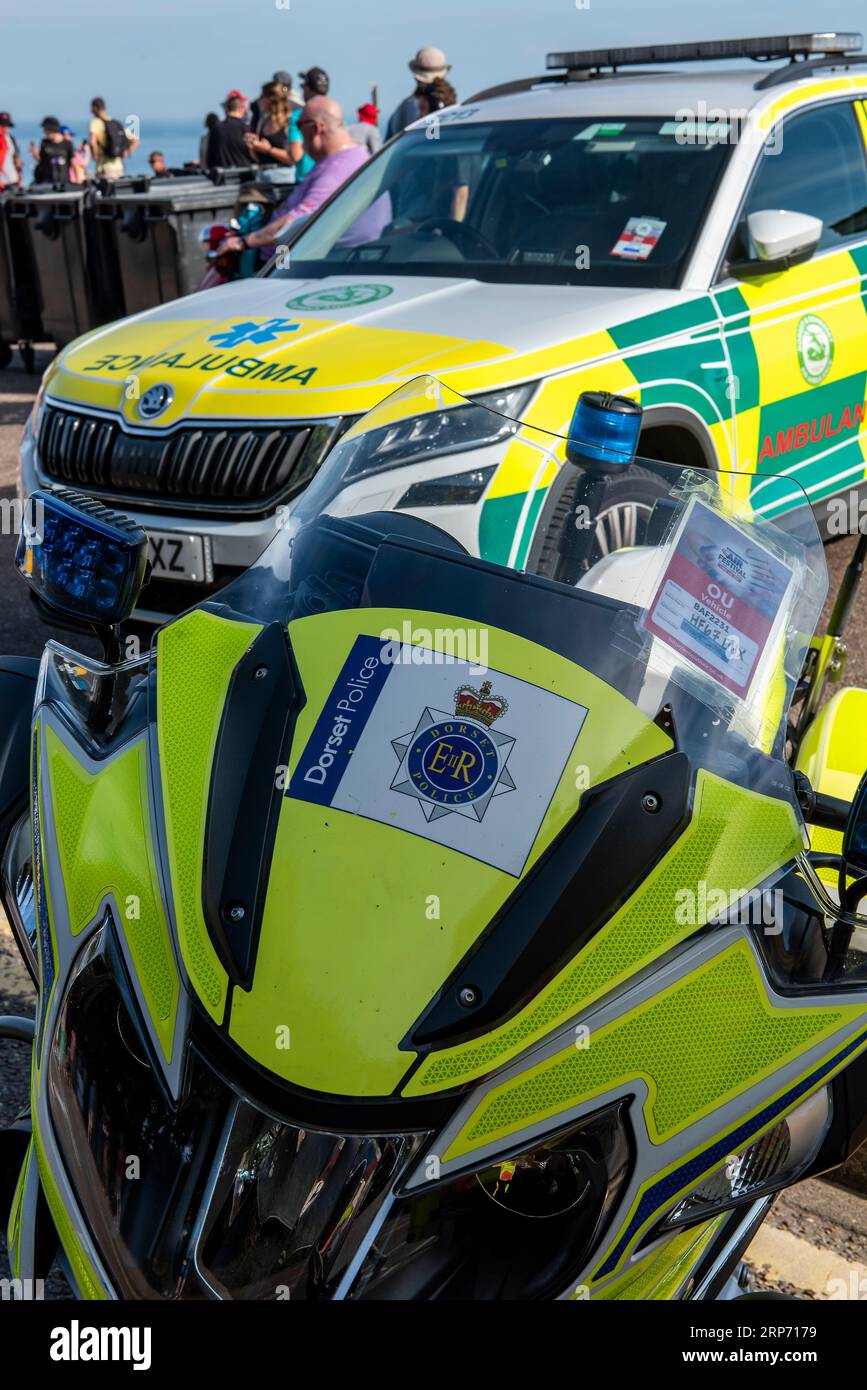police motorcycle and emergency ambulance response car at an event in ...