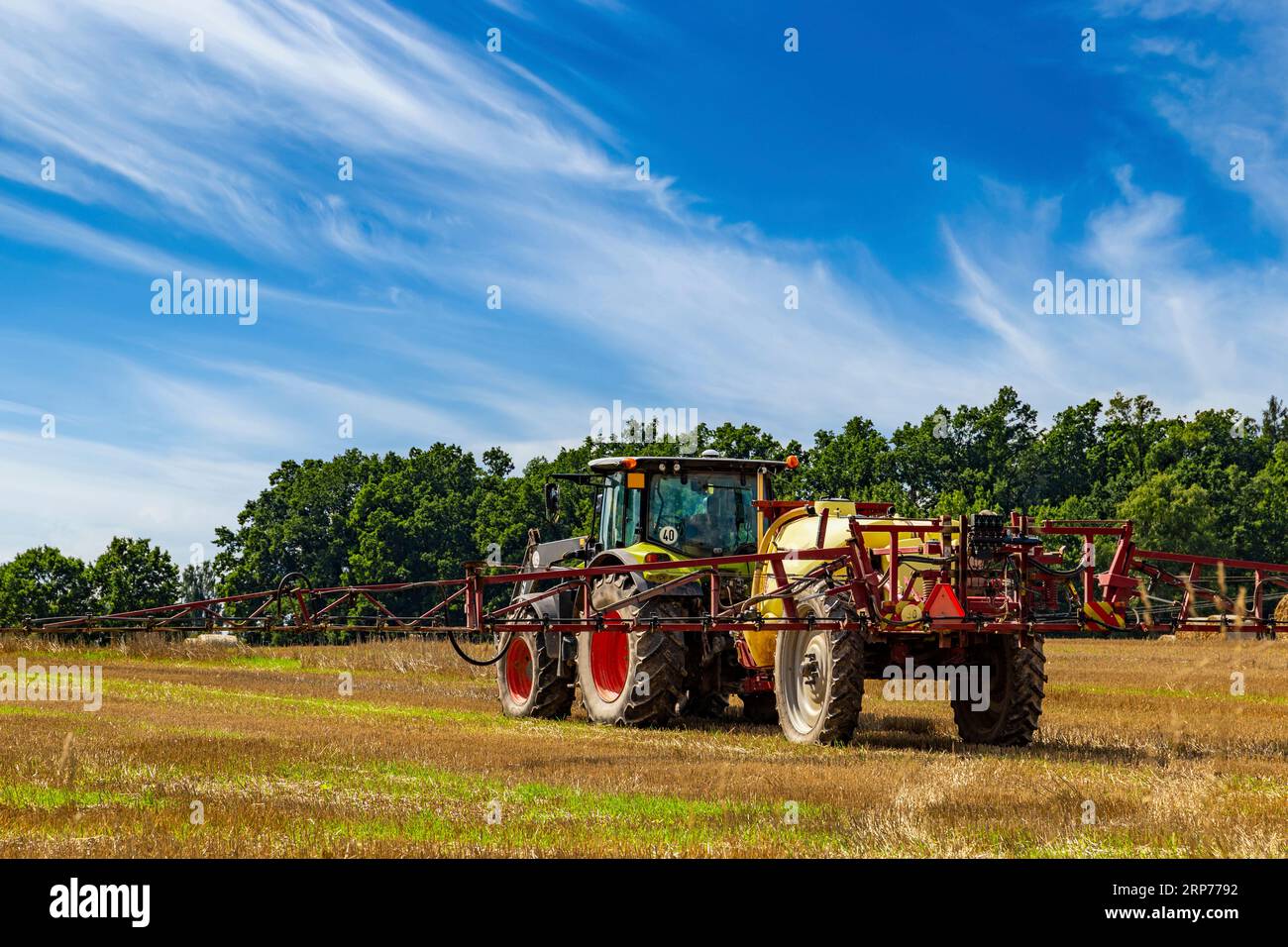 Agricultural machinery in summerfield. Rural landscape Stock Photo - Alamy