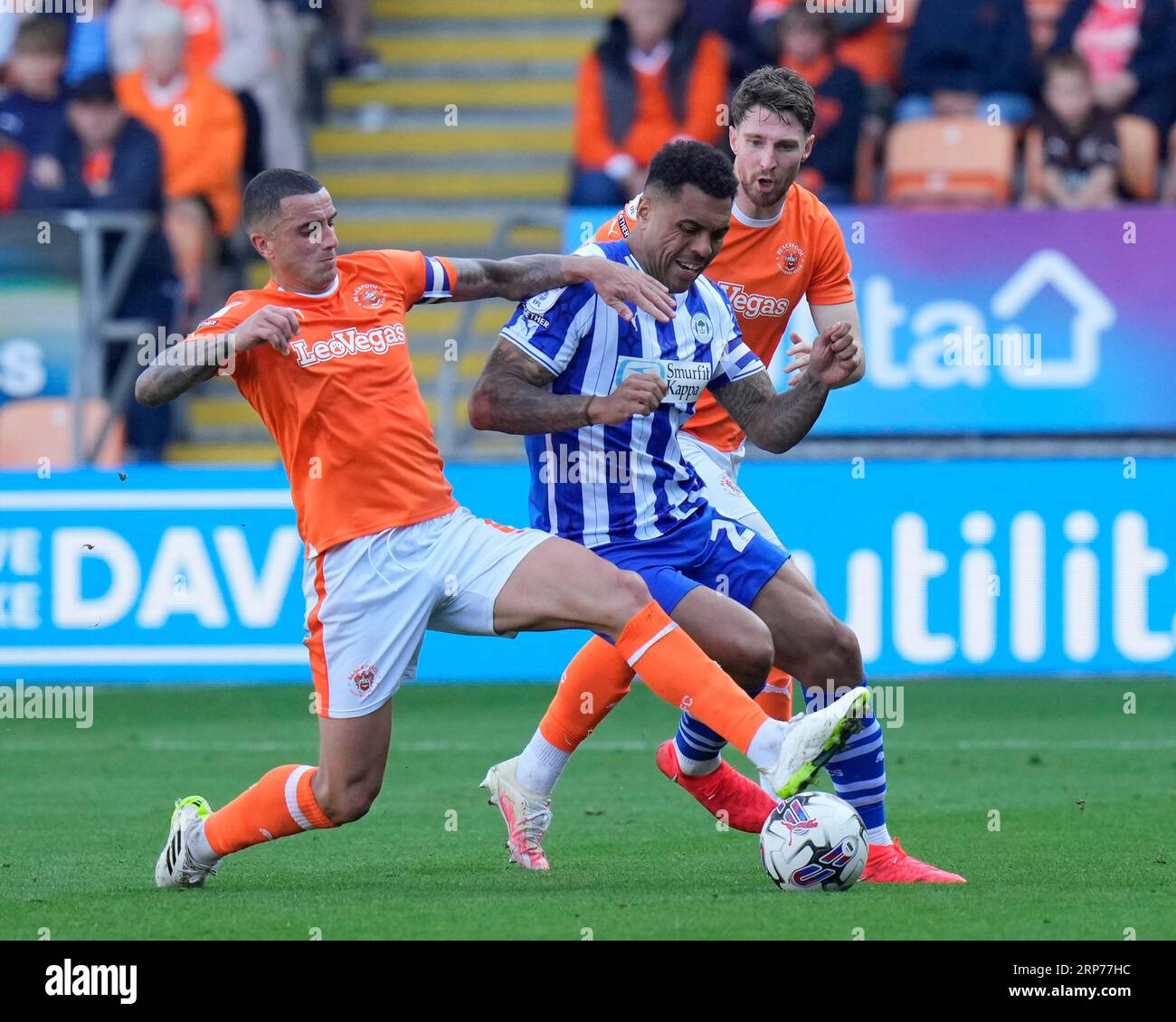 Oliver Norburn #6 of Blackpool competes for the ball with Josh Magennis ...