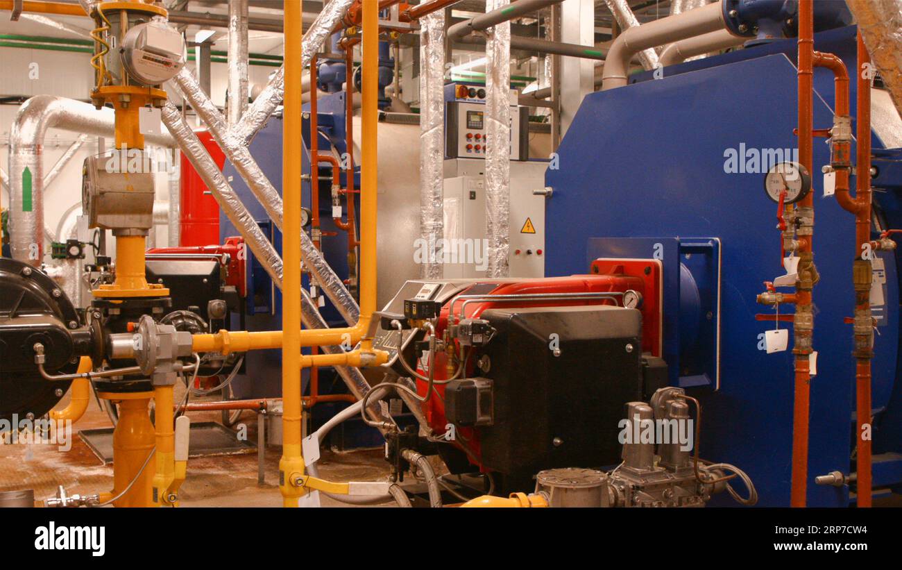 Heating pipes and boilers inside the boiler room Stock Photo - Alamy