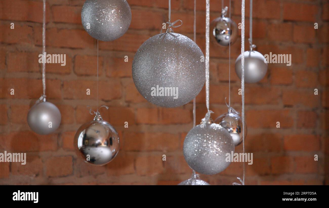 Silver Christmas balls on the background of a wall of red brick loft ...