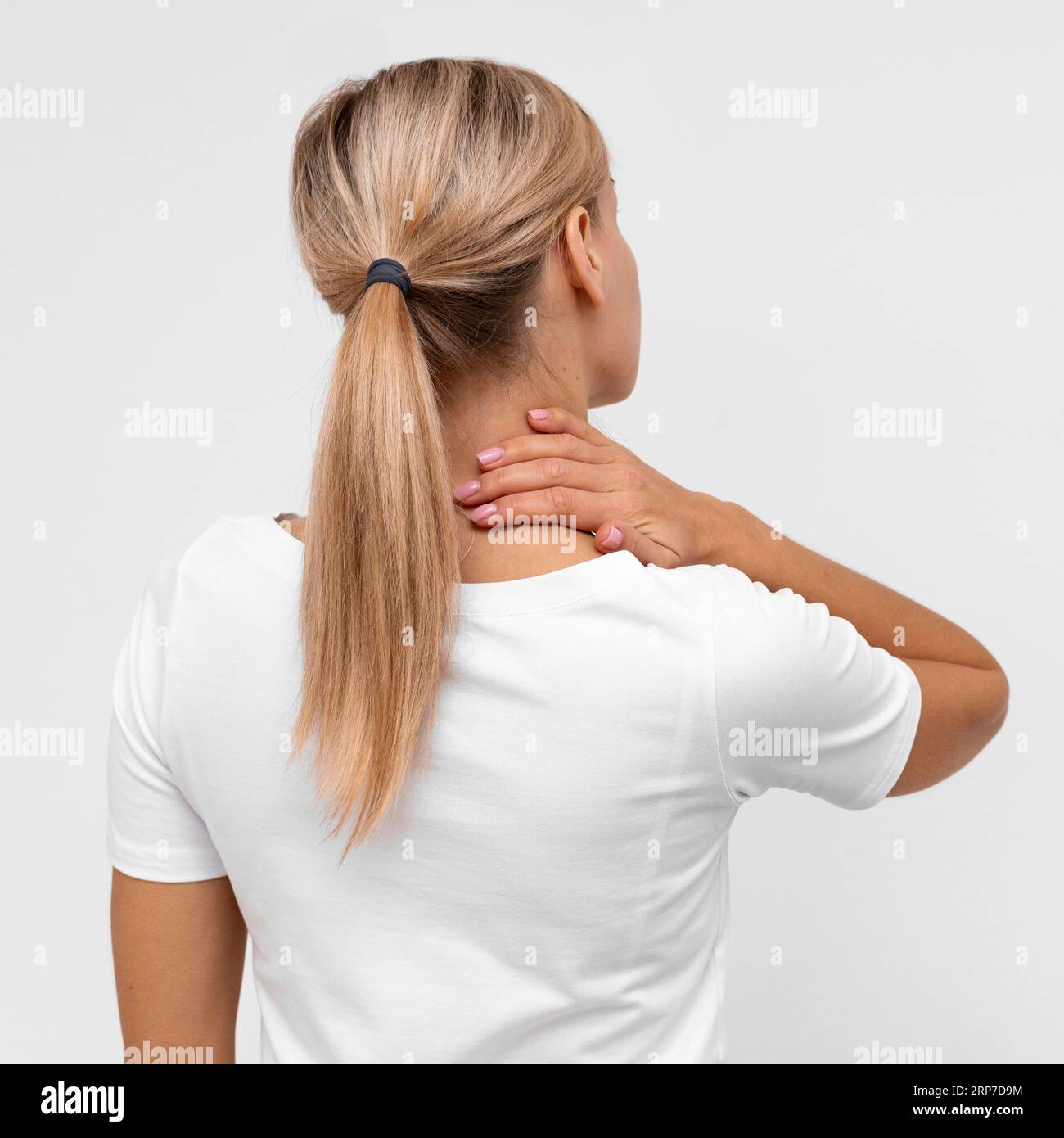 Back view woman with neck pain Stock Photo - Alamy