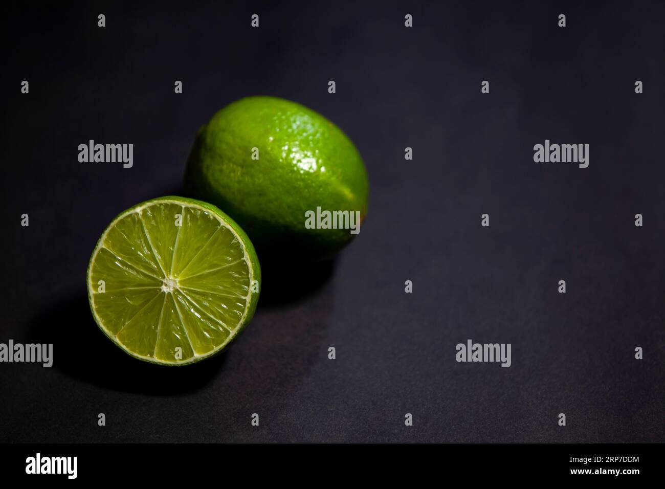 Limes against dark background, top view with copy space Stock Photo - Alamy