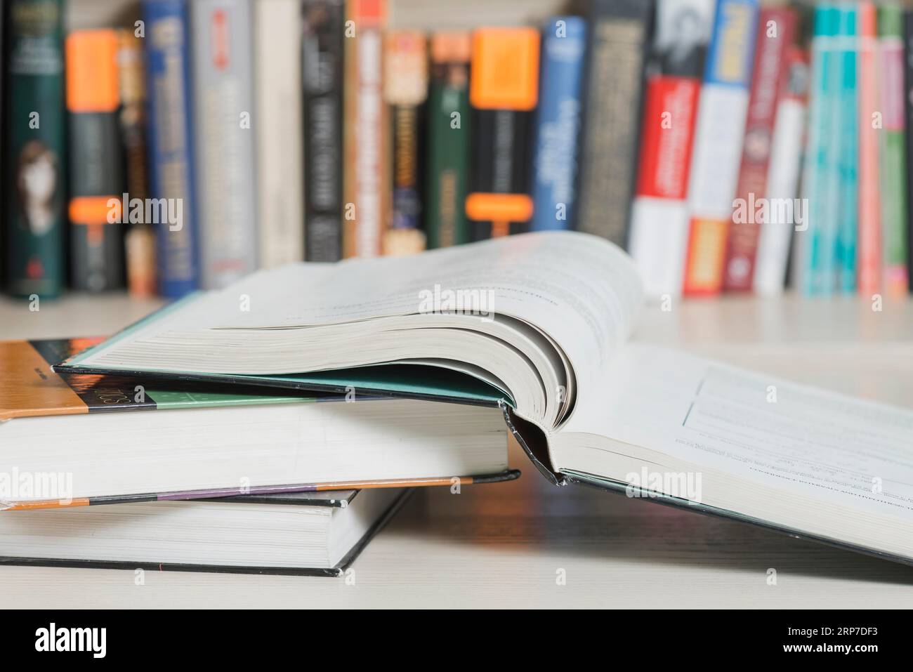 Books near bookcase Stock Photo - Alamy