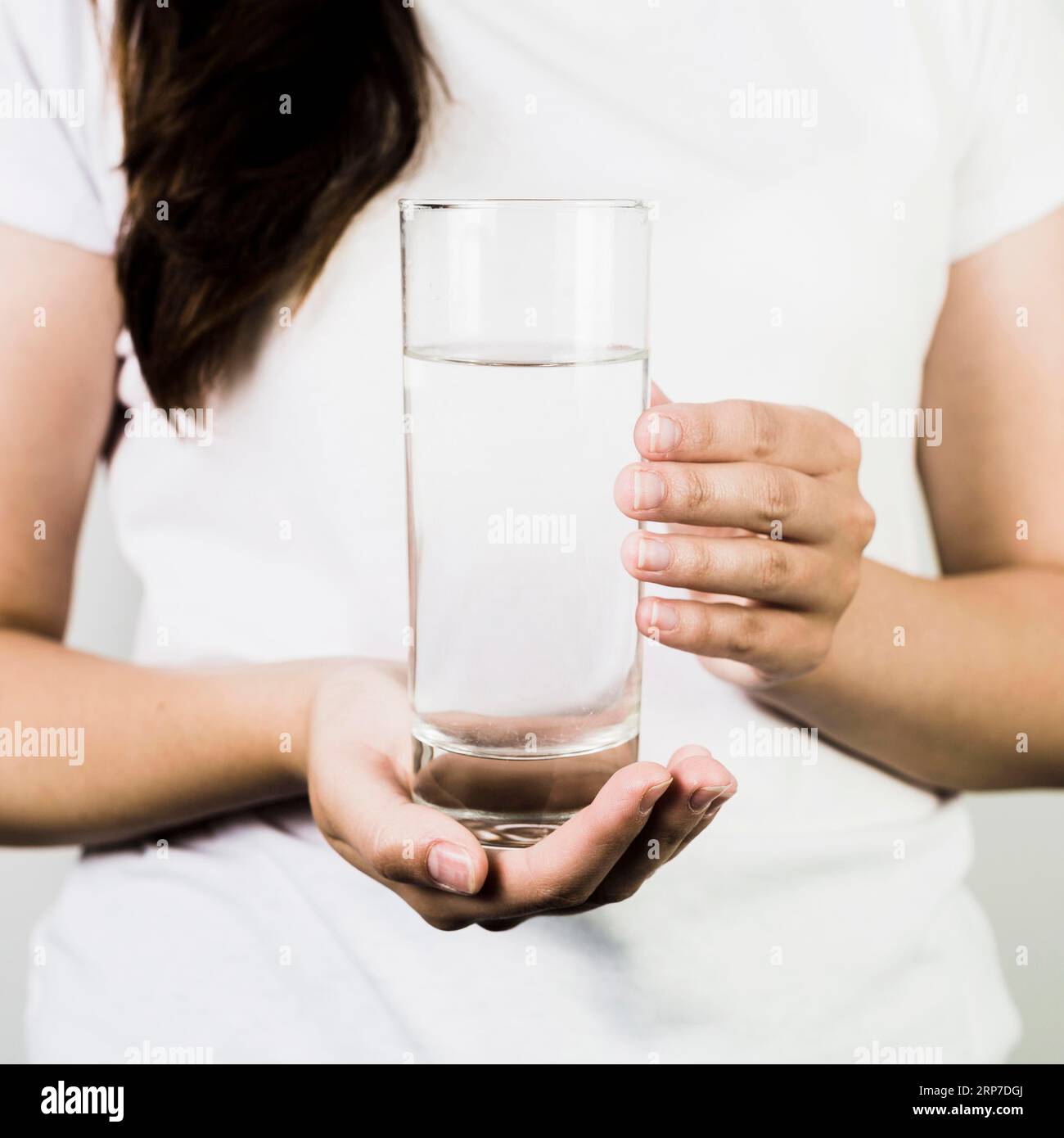 Crop female hands holding glass water Stock Photo - Alamy