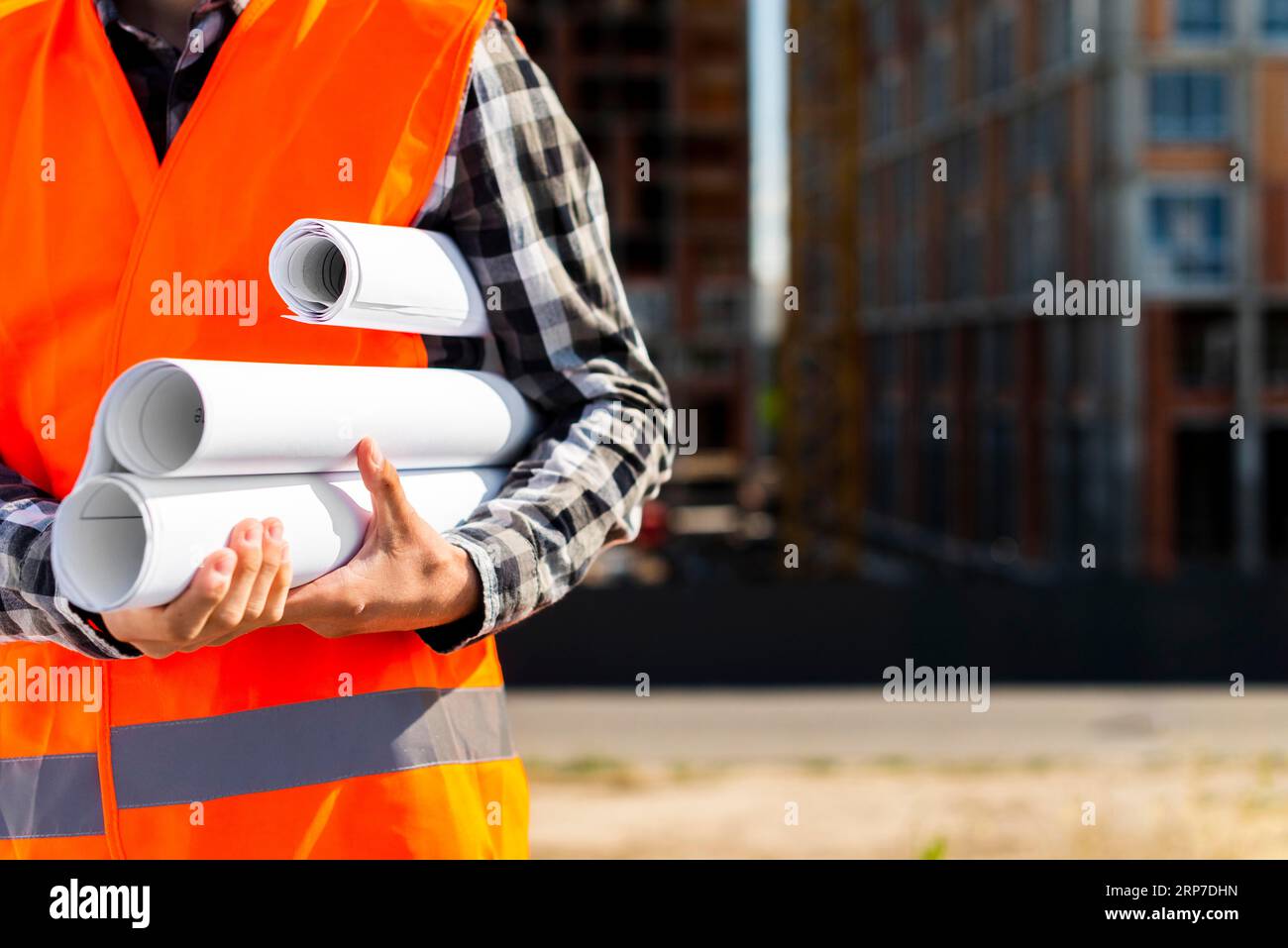Construction engineer holding plans hands Stock Photo - Alamy