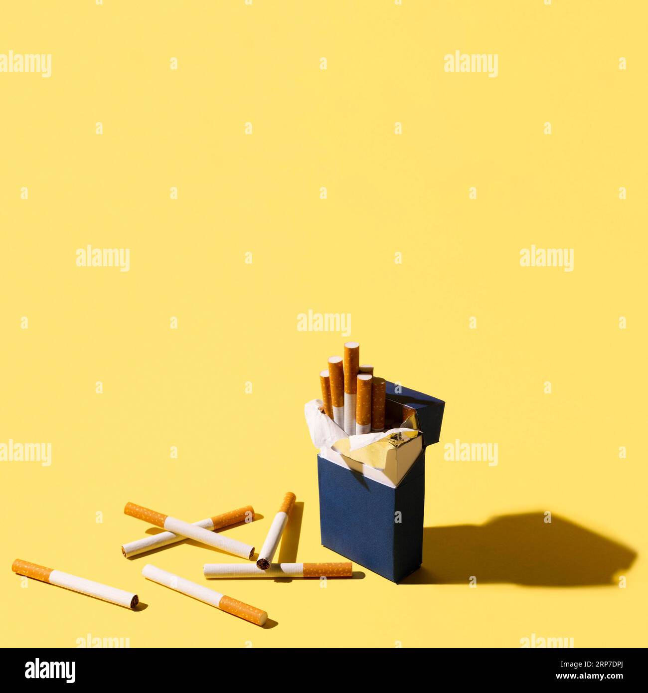 Cigarettes pack yellow background Stock Photo - Alamy