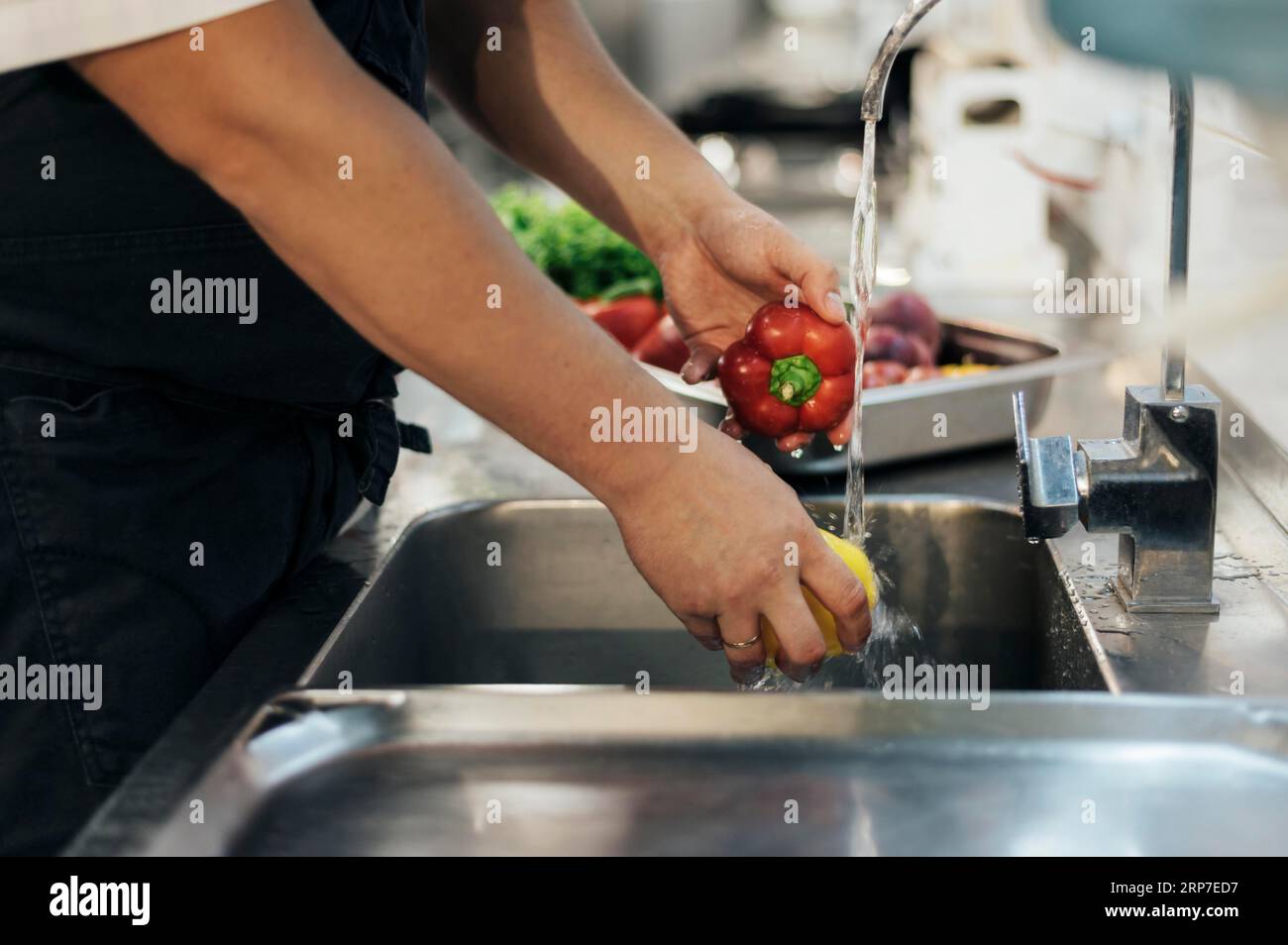 Side view male chef washing vegetables Stock Photo - Alamy
