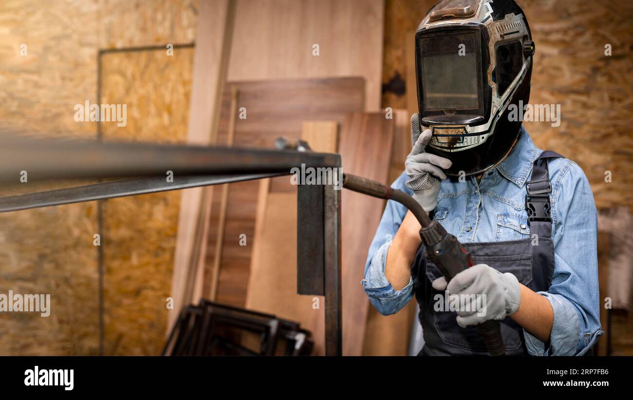 Front view woman with welding tool mask Stock Photo - Alamy
