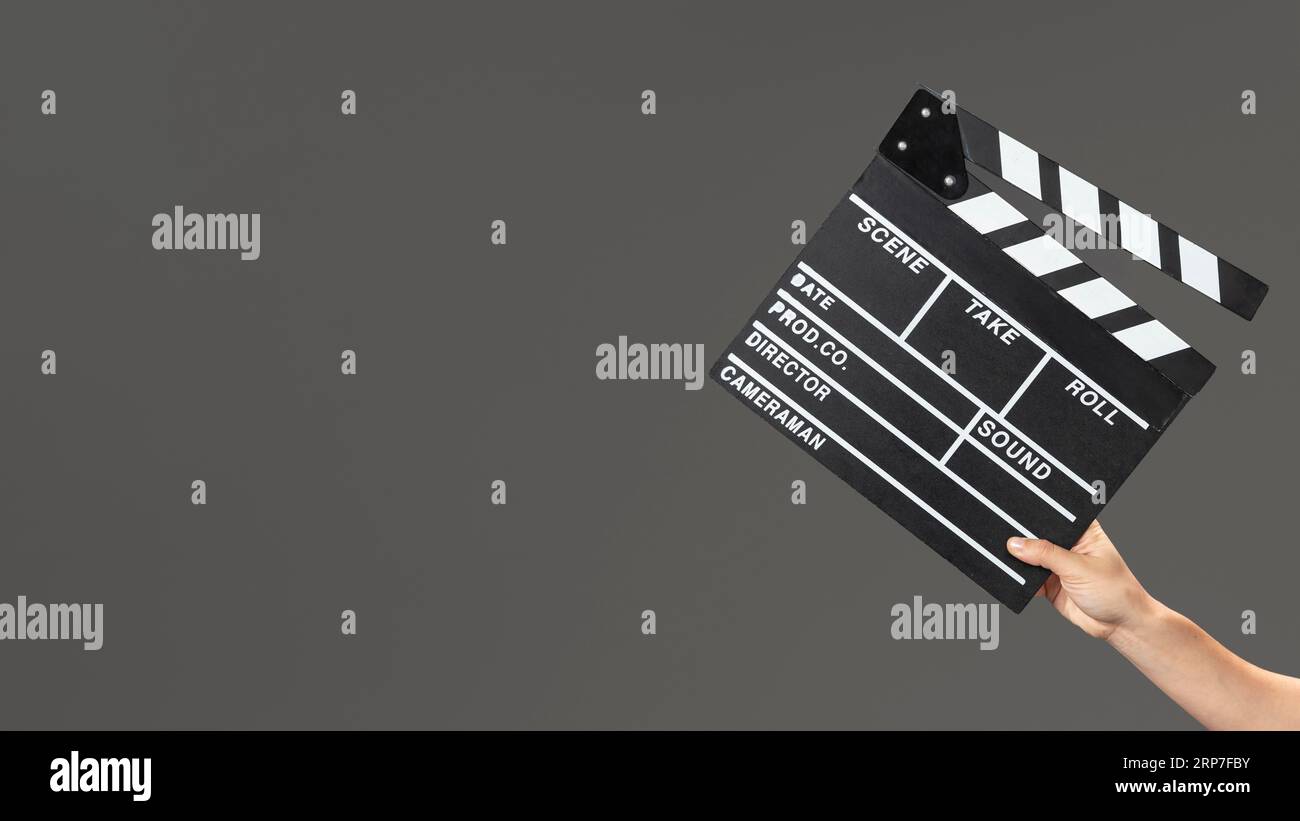Hand with movie slate Stock Photo - Alamy
