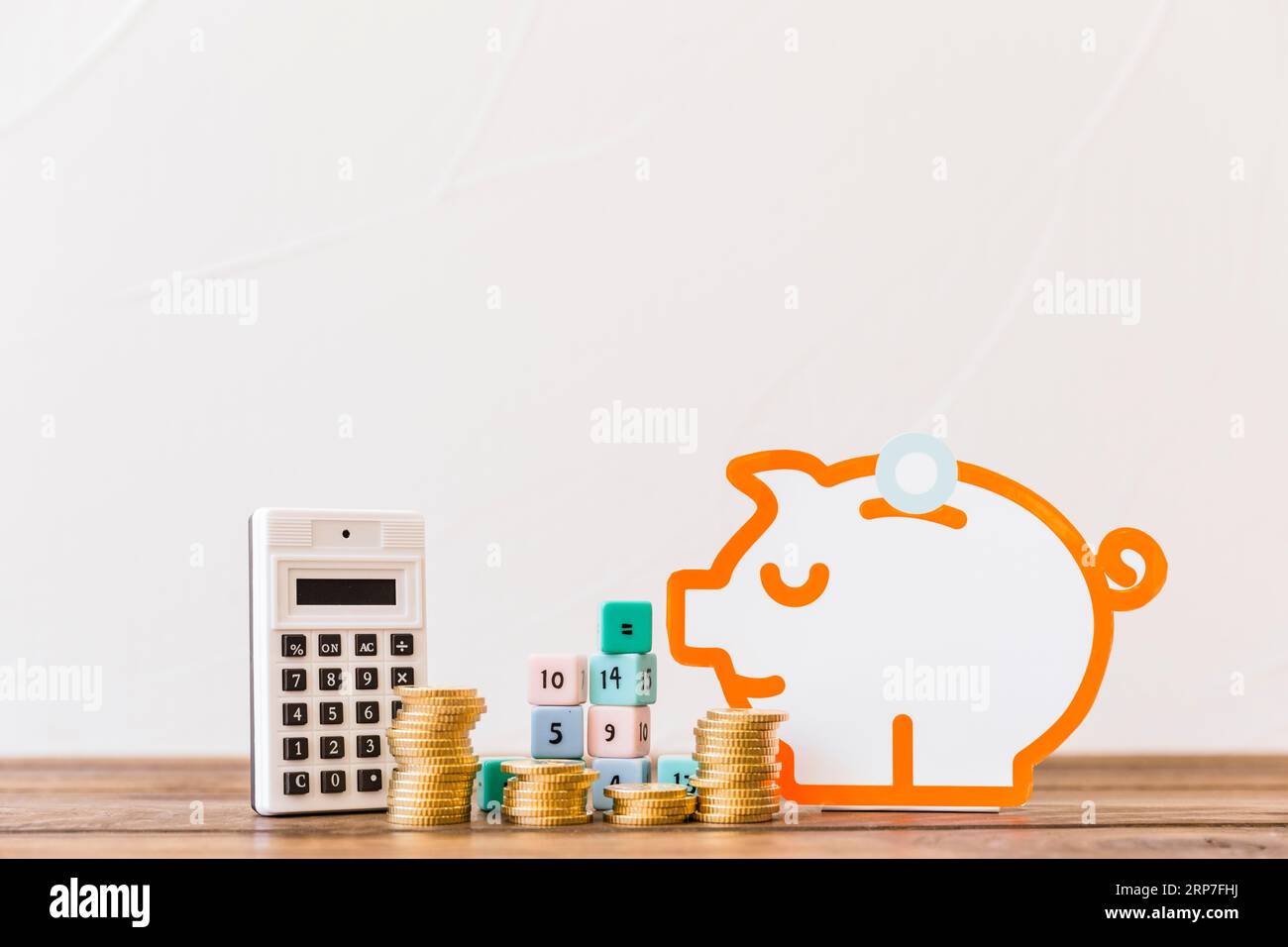 Stacked coins math blocks calculator piggybank wooden tabletop Stock ...