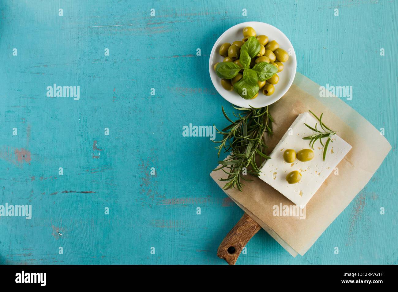 Blue background olives cheese aromatic herb Stock Photo - Alamy