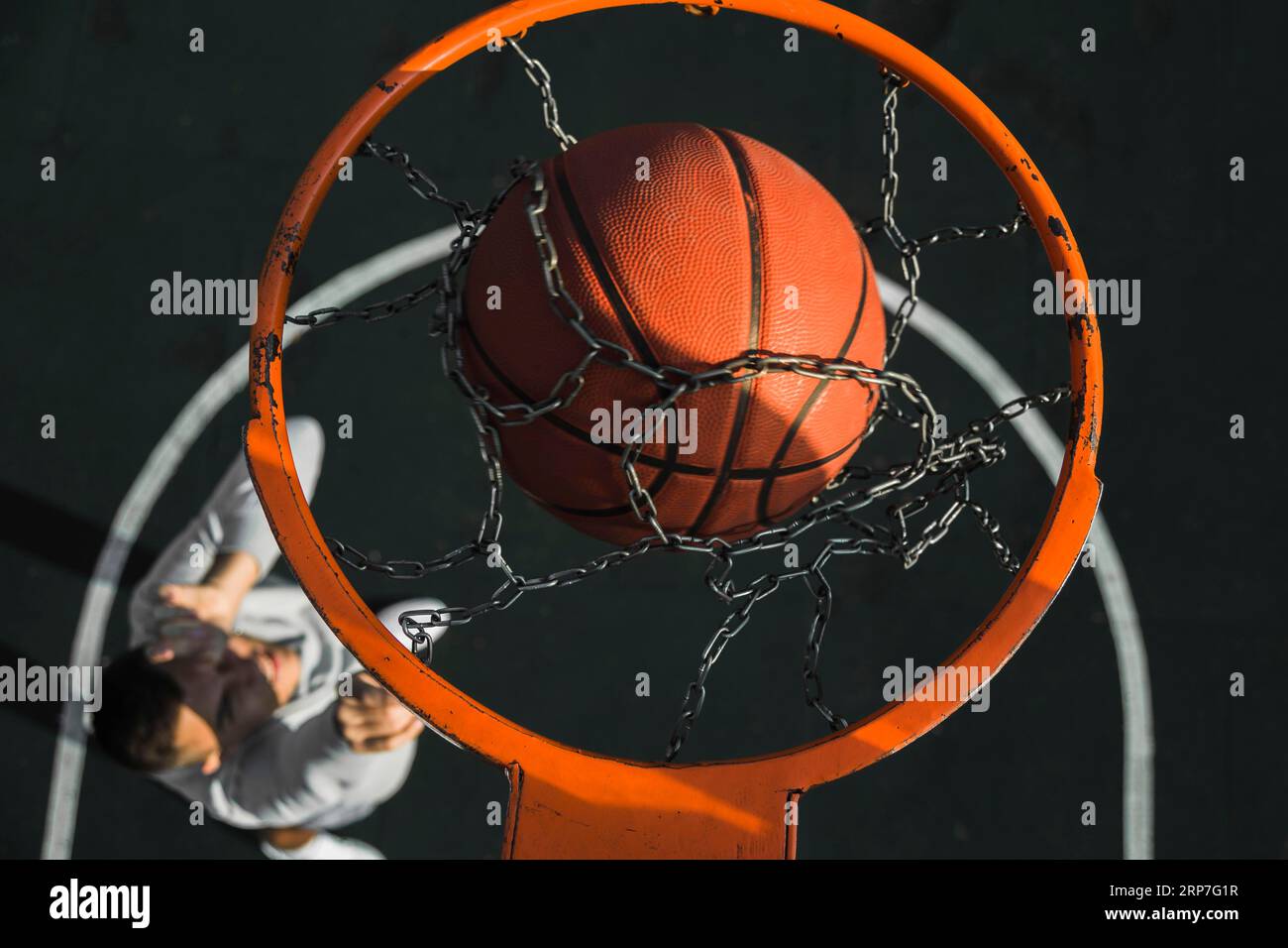 Basketball falling through ring Stock Photo - Alamy
