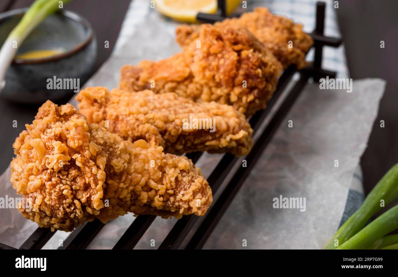 Fried chicken wings tray green onions Stock Photo - Alamy