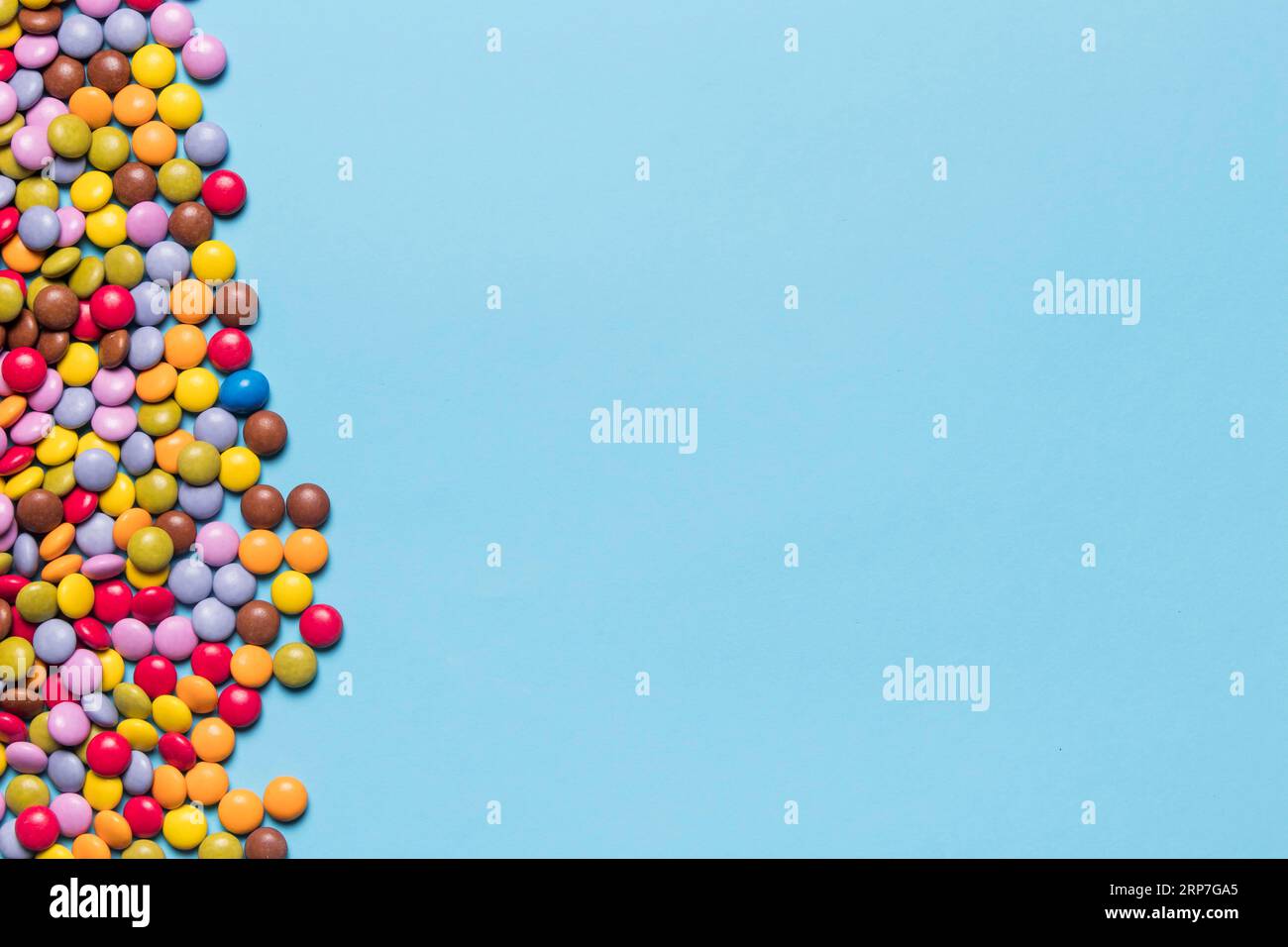 Colorful gem candies side blue background Stock Photo - Alamy