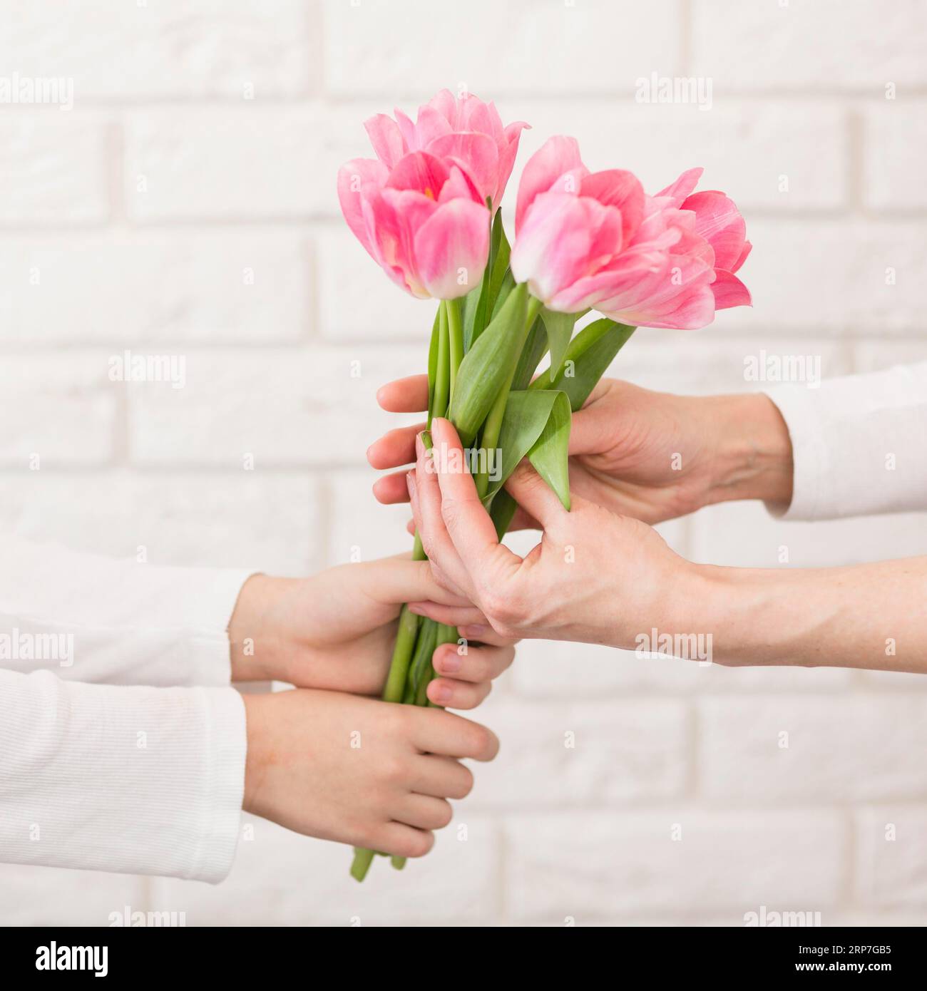 Boy offering flowers mother Stock Photo - Alamy