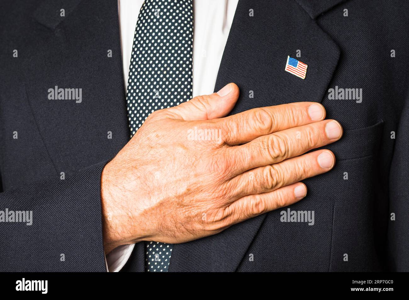 Patriotic man usa badge his black coat touching hand his chest Stock ...