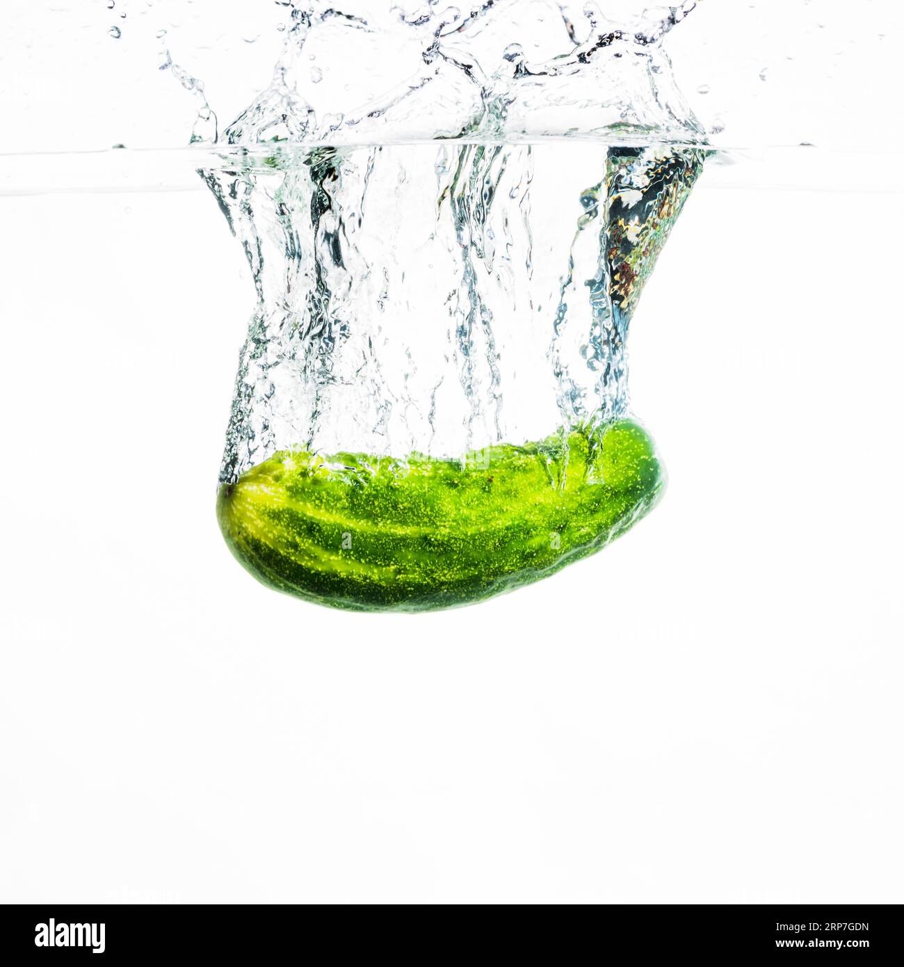 Cucumber falling water water splash against white background Stock ...