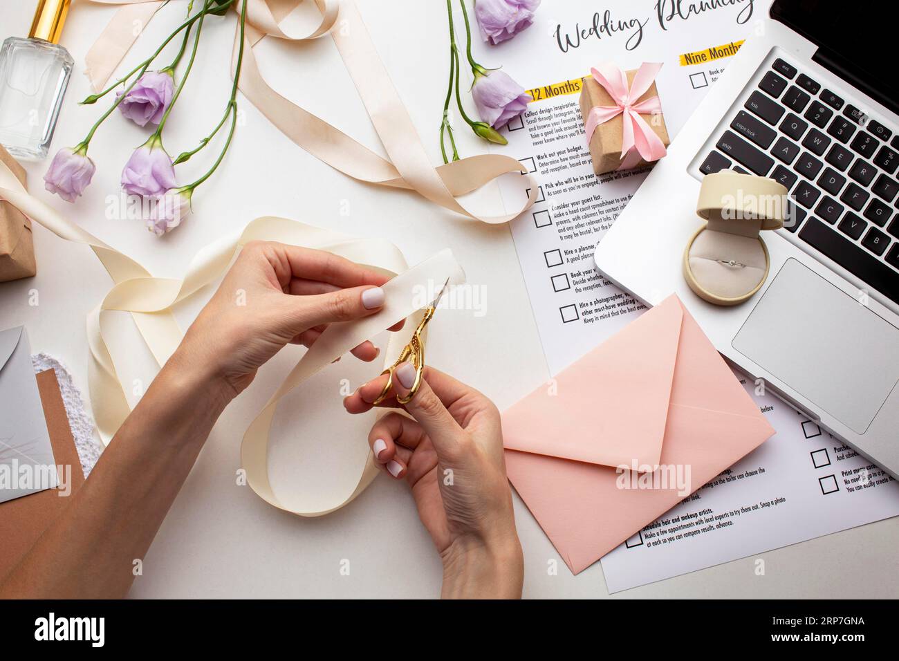 Feminine hands creating handmade invitations Stock Photo - Alamy