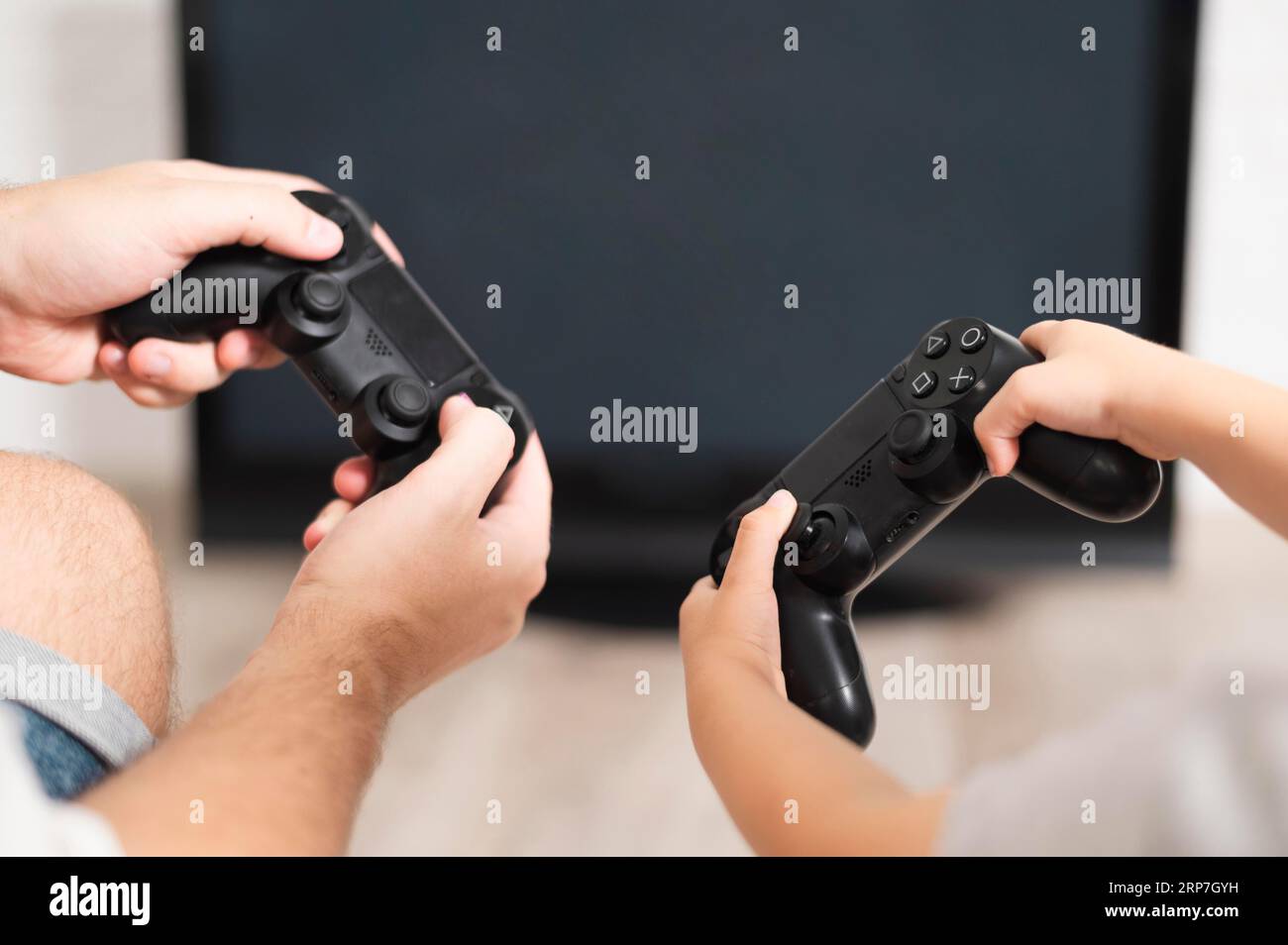 Front view father son playing controllers Stock Photo - Alamy