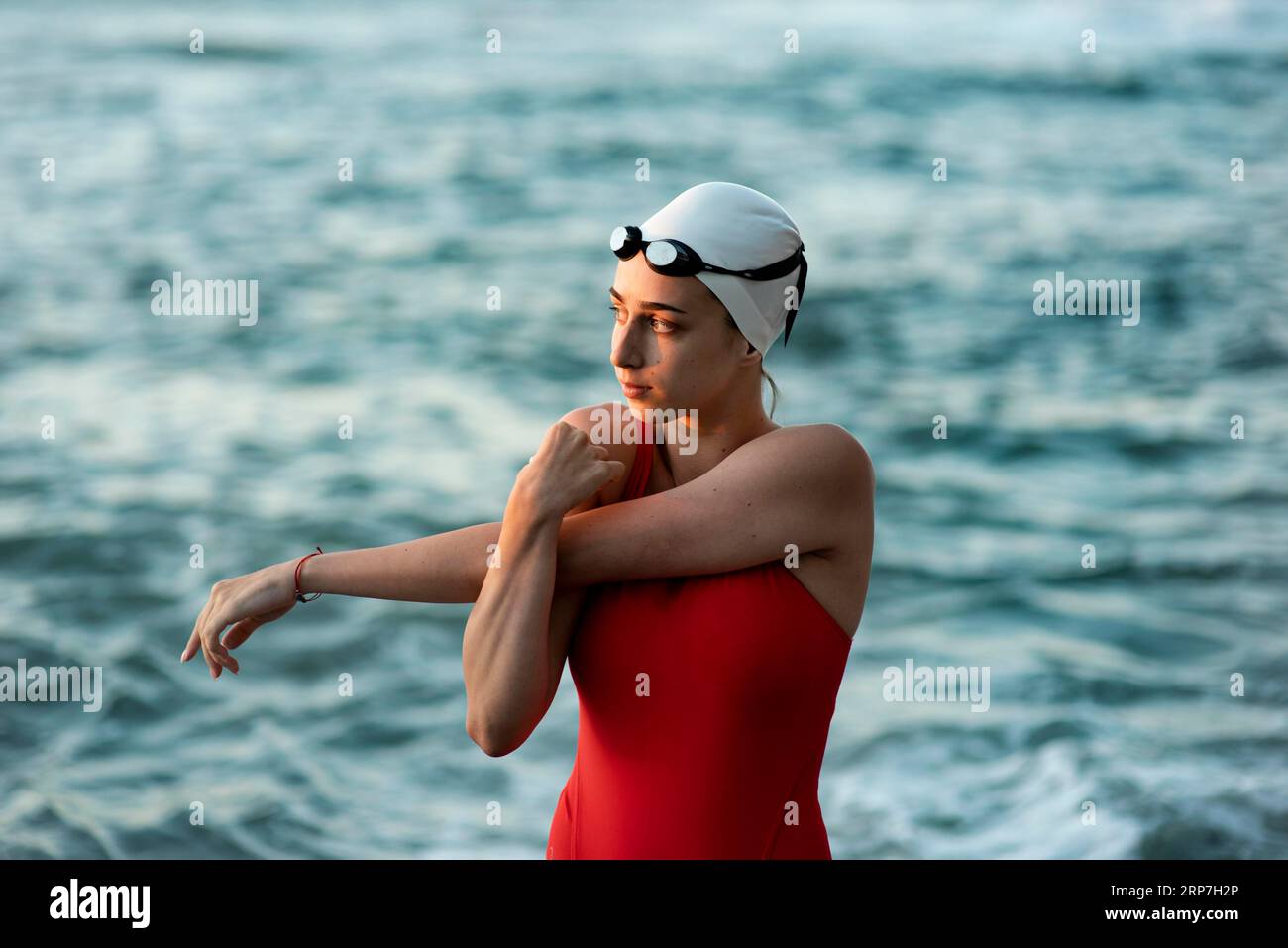 Front view female swimmer stretching before swimming Stock Photo - Alamy