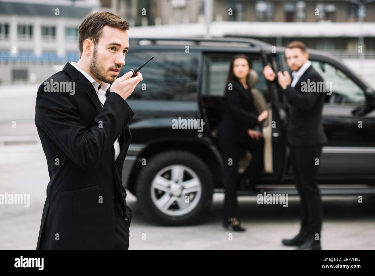 Side view security men working Stock Photo - Alamy