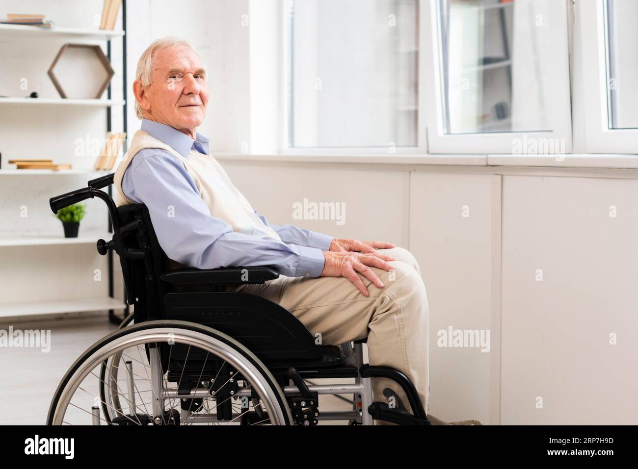 Side view elder sitting wheelchair Stock Photo - Alamy