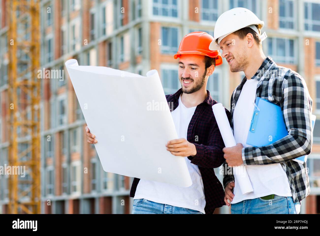 Medium shot side view engineer architect supervising construction Stock ...