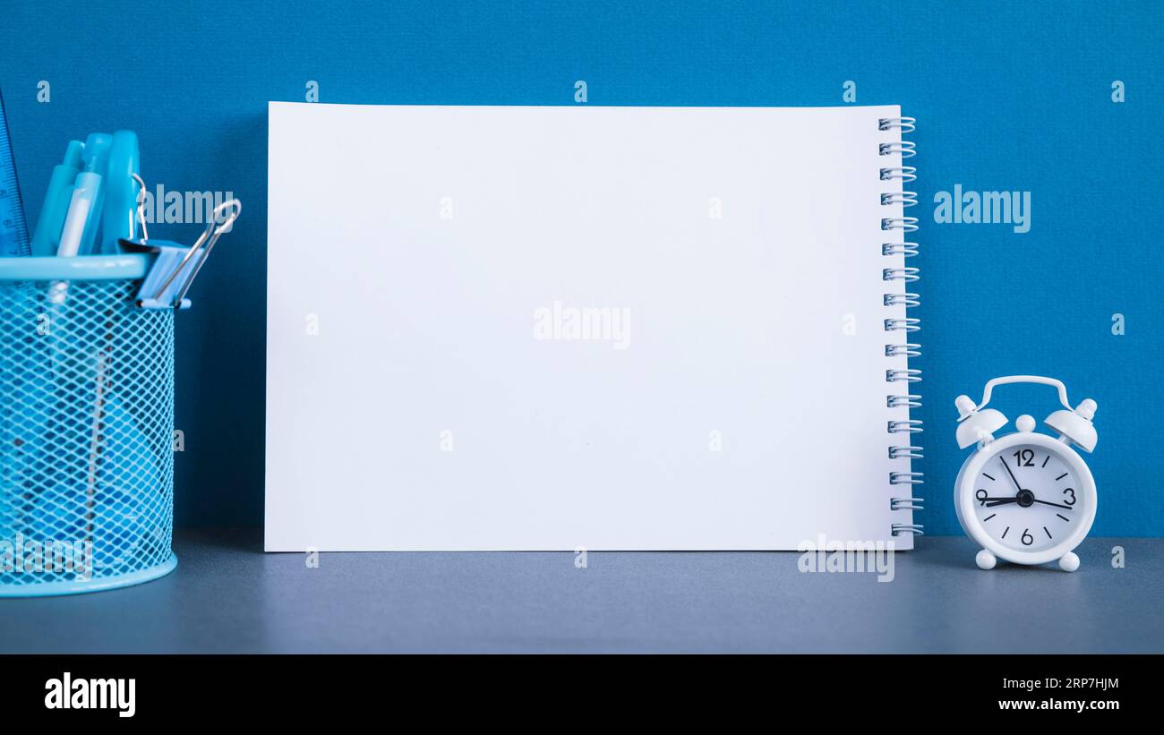 Spiral notepad stationery round alarm clock Stock Photo - Alamy