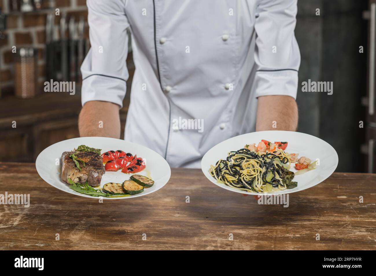 Hand presenting food plate hi-res stock photography and images - Alamy