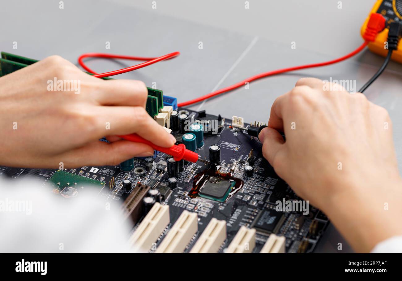 High angle female technician repairing computer motherboard Stock Photo ...