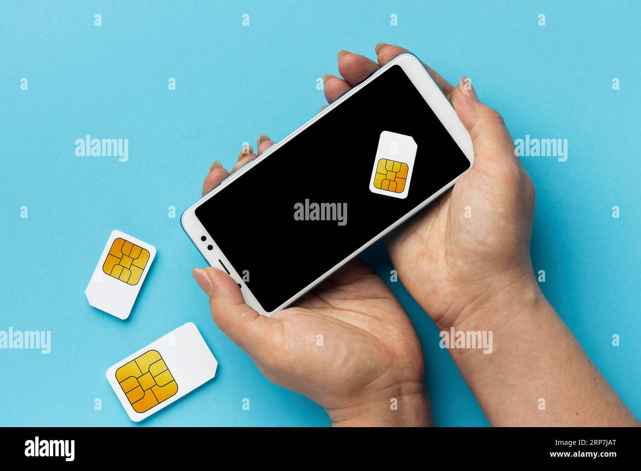 Front view hands holding smartphone sim cards Stock Photo - Alamy