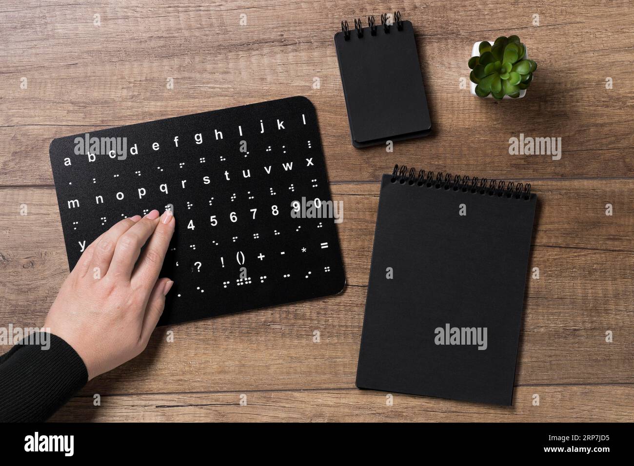 Hand reading braille alphabet board Stock Photo - Alamy