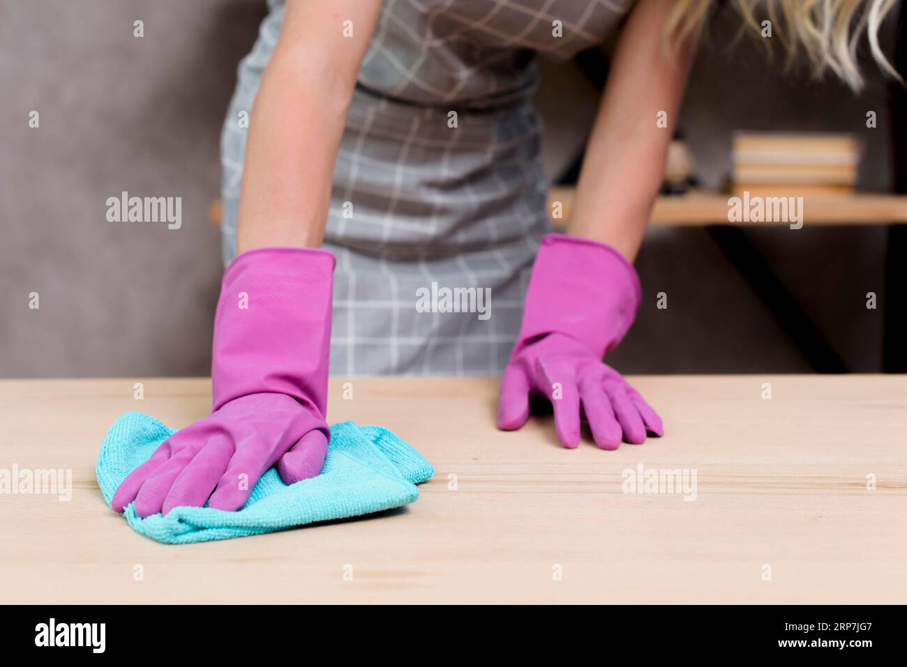 Midsection female janitor wiping wooden table with cloth Stock Photo ...