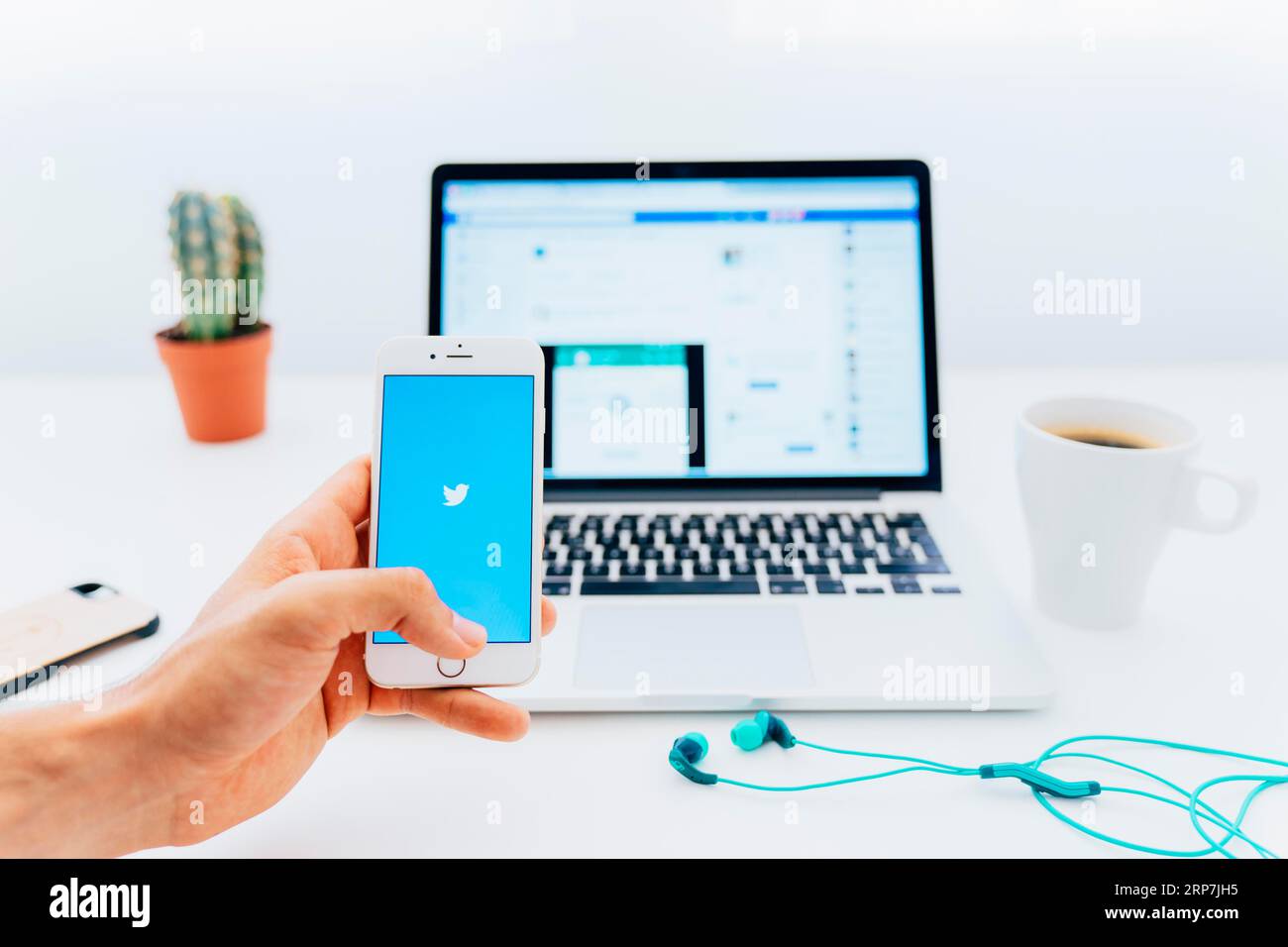Phone with twitter laptop with facebook Stock Photo - Alamy