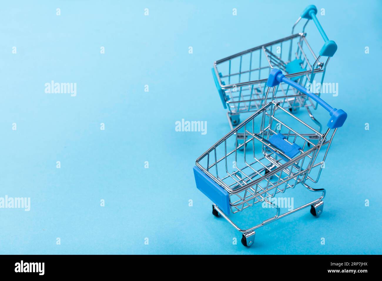 Shopping carts blue background with copy space Stock Photo - Alamy